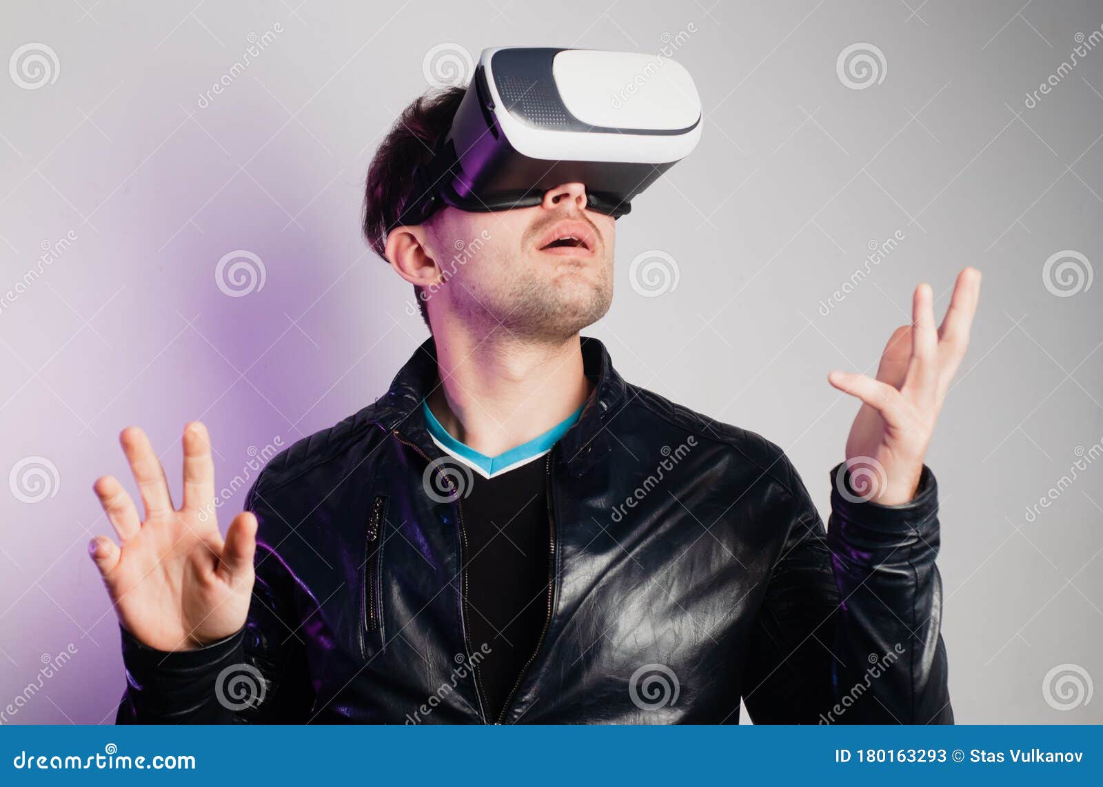 A Guy in a Leather Jacket Plunges into Virtual Reality Using VR Glasses ...