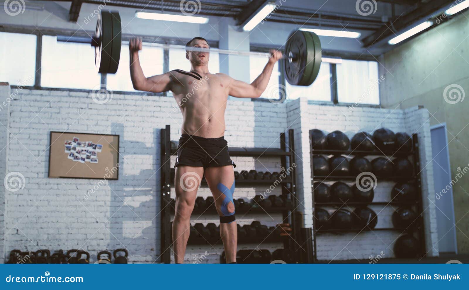 Guy lifting heavy weights. stock video. Video of abdominal - 129121875