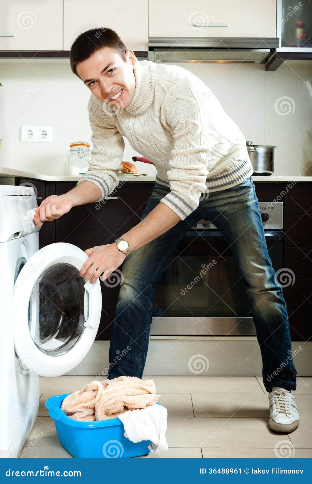 Guy Loading Clothes into the Washing Machineading Clothes into Stock ...