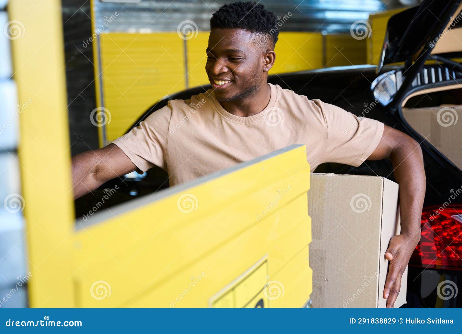 Guy Loads a Cardboard Box with Things into Yellow Cell Stock Image ...