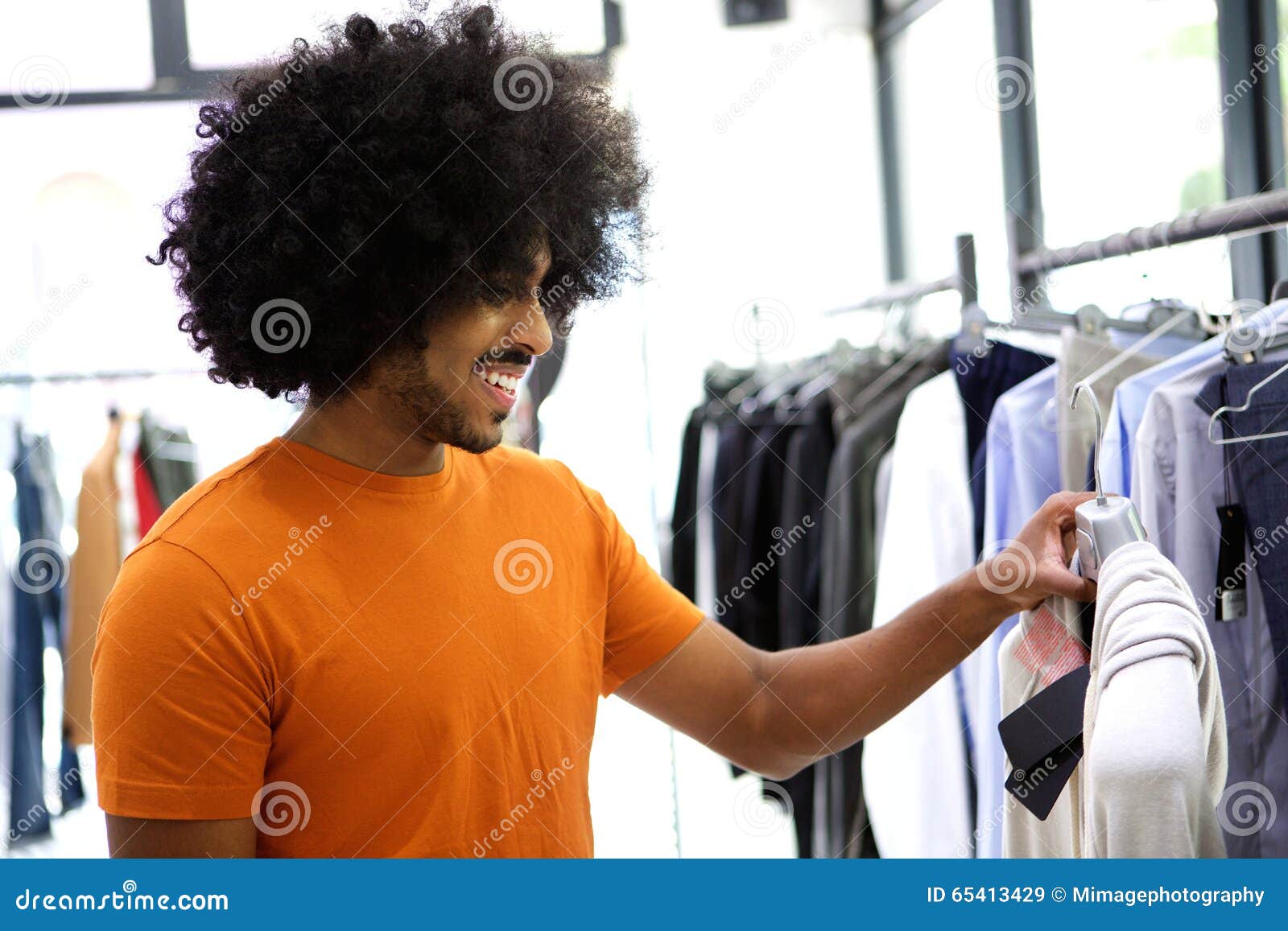 Guy Looking at Clothes in Store Stock Image - Image of clothing ...