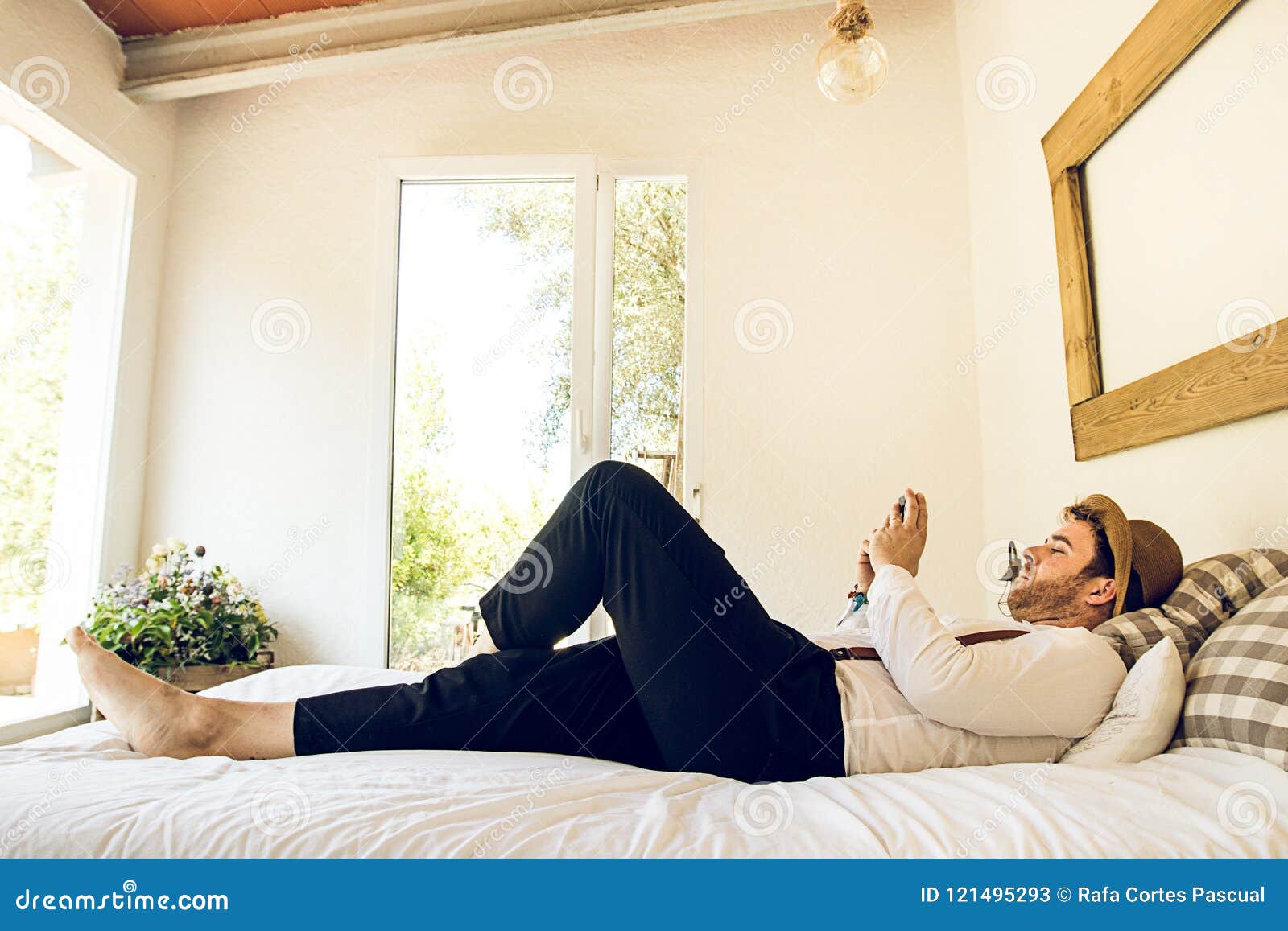 Guy Looking at His Cell Phone in Bed Stock Image - Image of smart ...