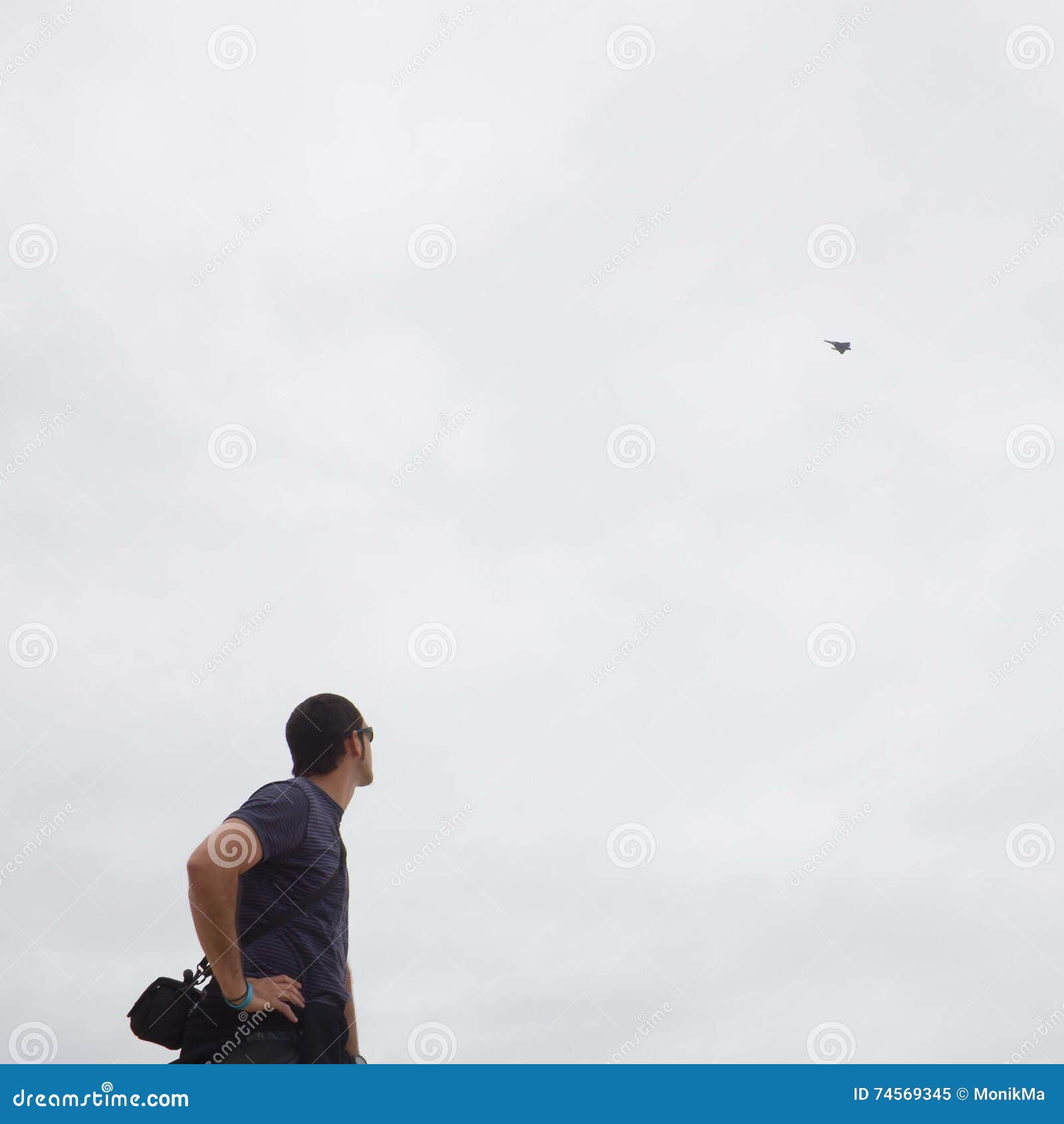 Guy Looking Up To a Fighter Plane Stock Image - Image of cloudy, plane ...