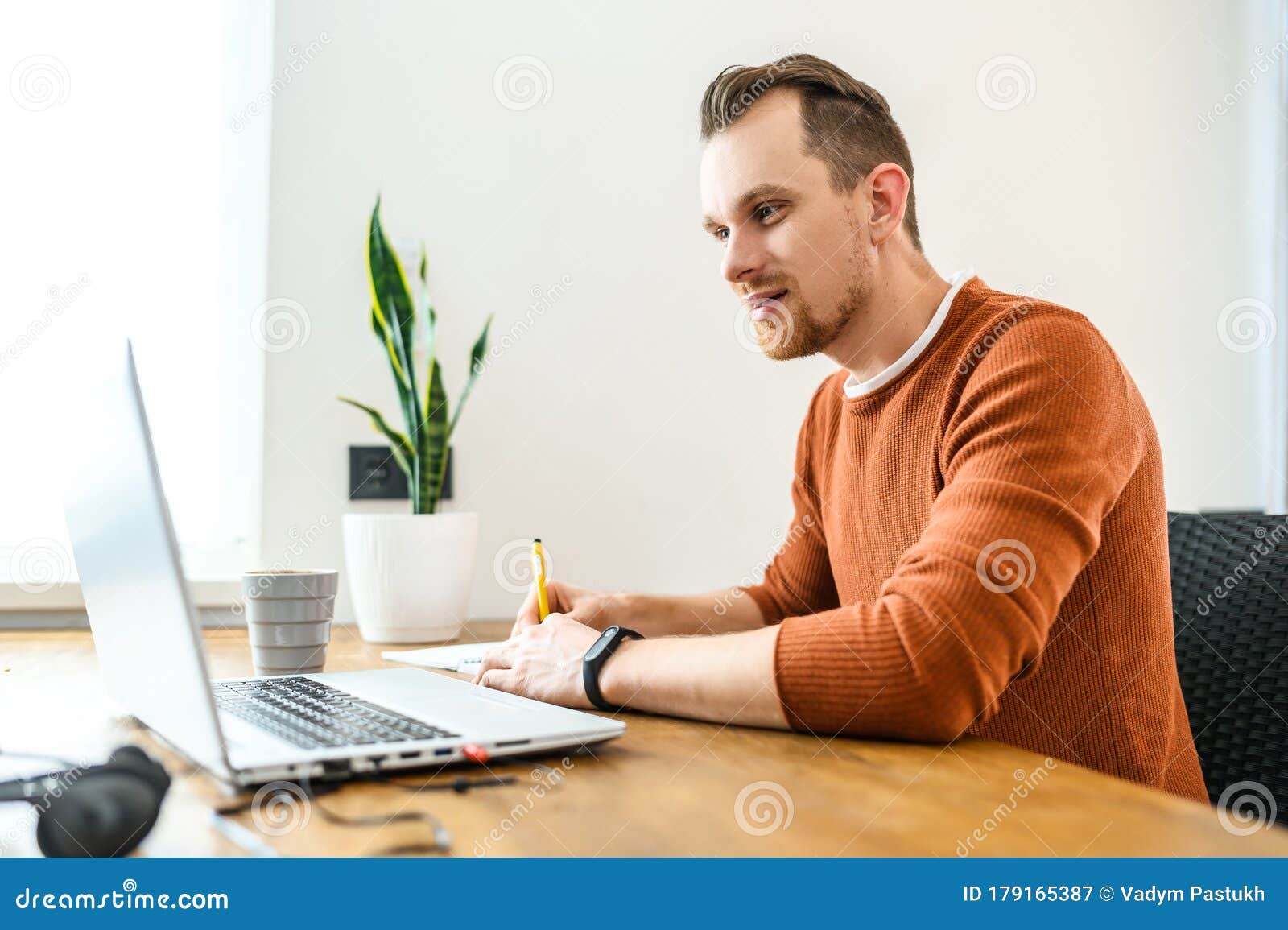 Guy Looks at Laptop and Notes in Notebook Stock Image - Image of person ...