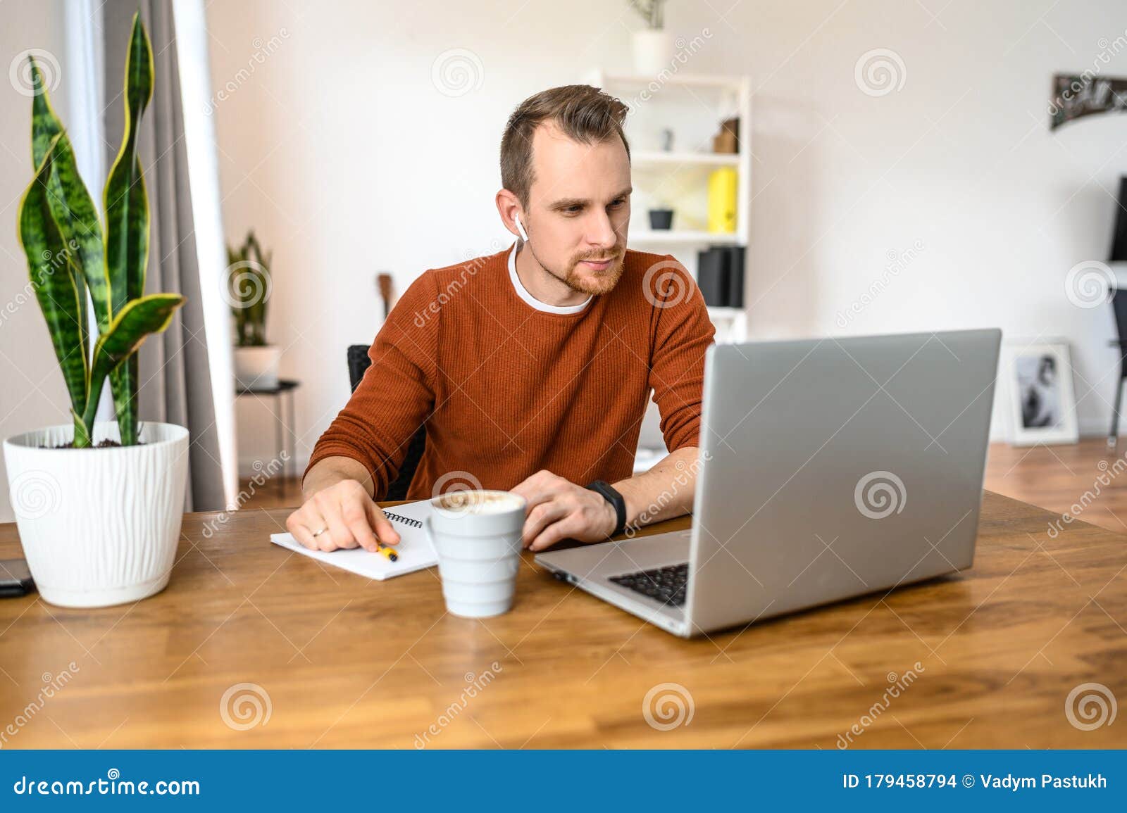 Guy Looks at Laptop and Notes in Notebook Stock Photo - Image of ...
