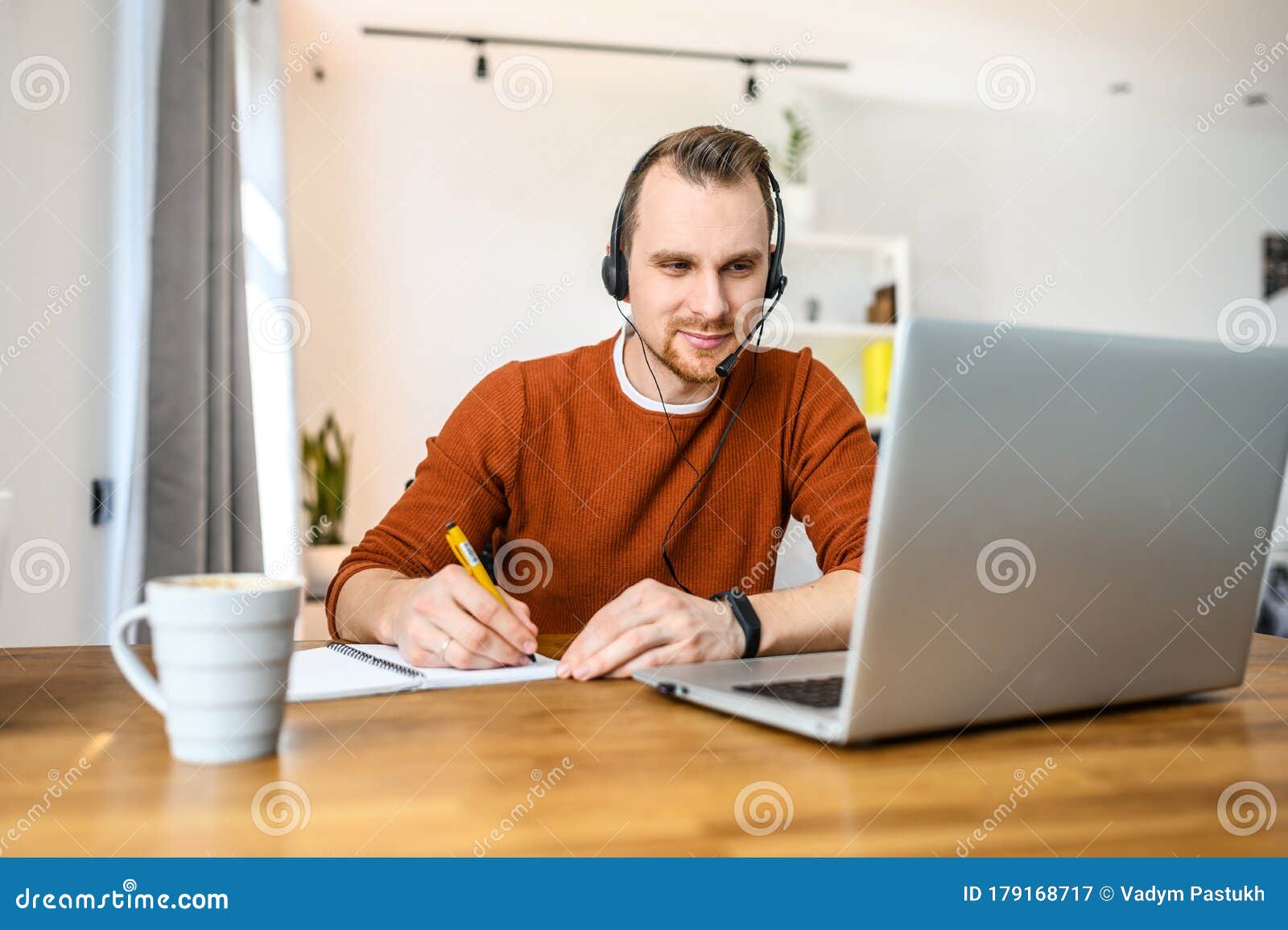 Guy Looks at Laptop and Notes in Notebook Stock Image - Image of ...