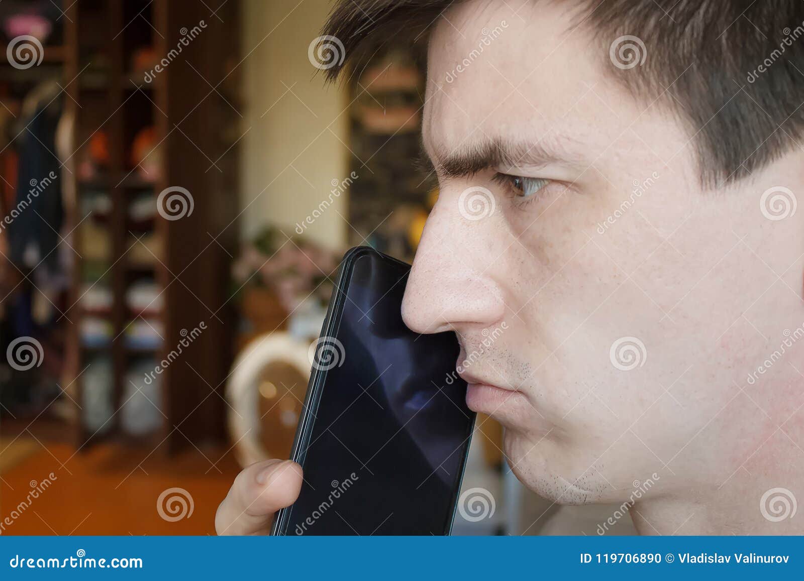 Guy Looks at the Screen of a Black Smartphone, through the Reflection ...