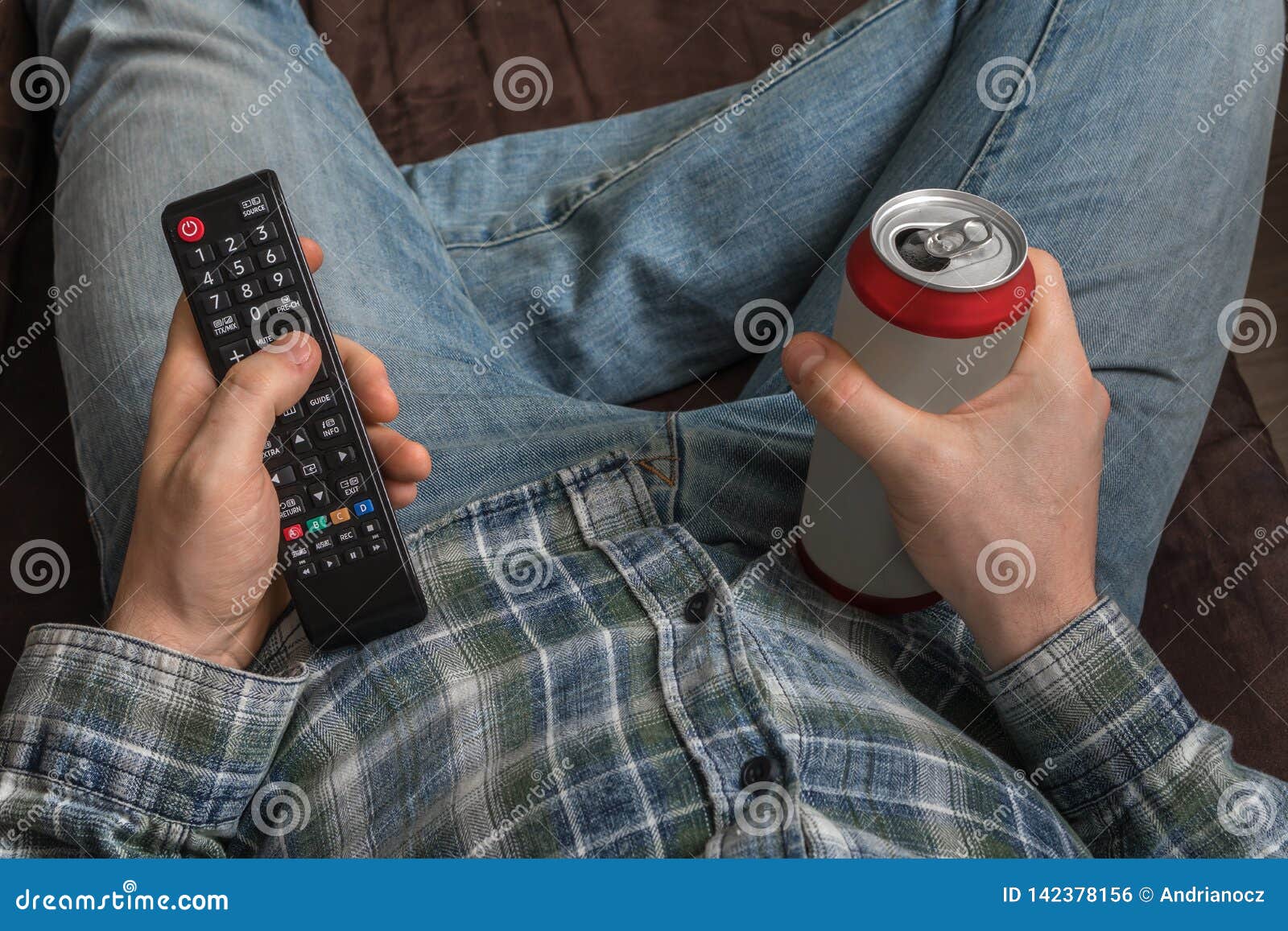 Guy is Lying on Sofa with TV Remote Control and Drinking Beer Stock ...