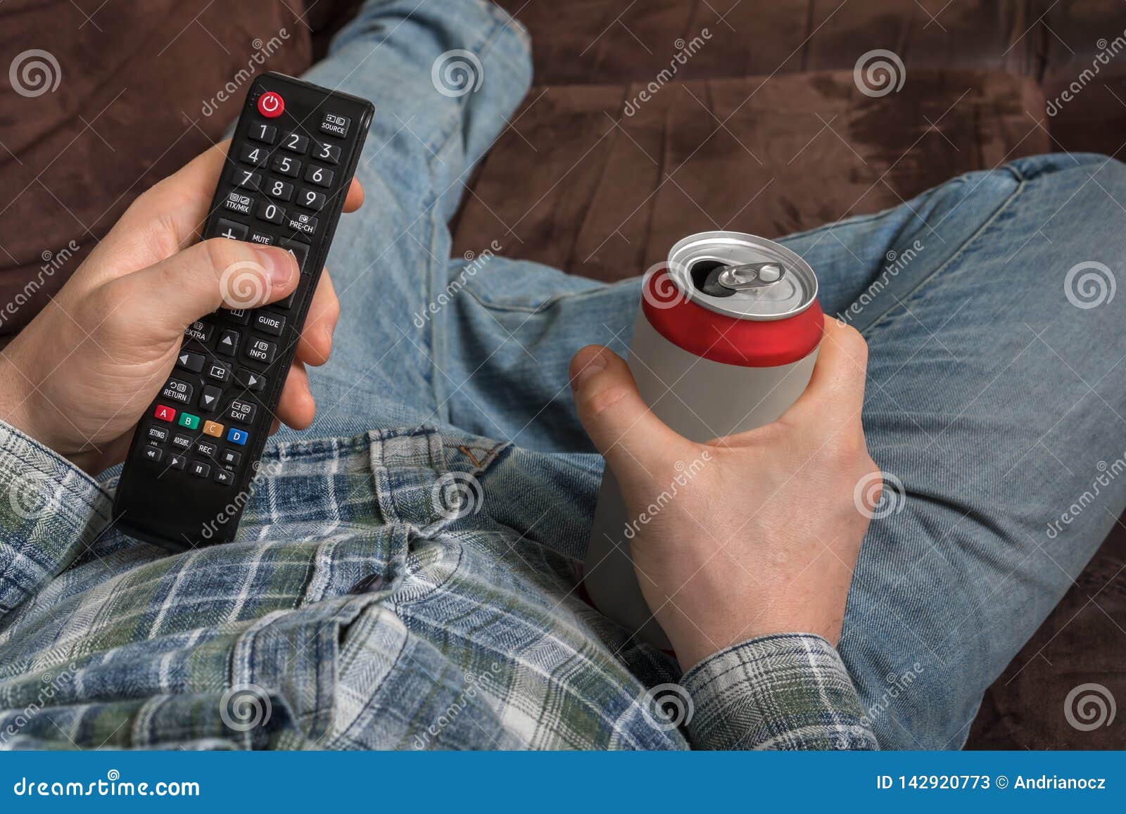 Guy is Lying on Sofa with TV Remote Control and Drinking Beer Stock ...