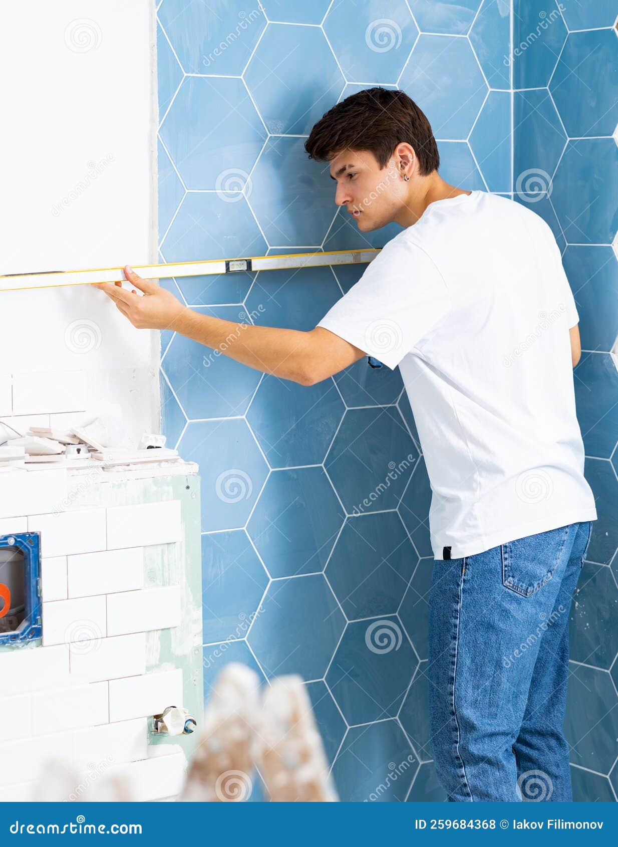 Guy Measuring Wall Flatness with Level Meter while Renovating House ...