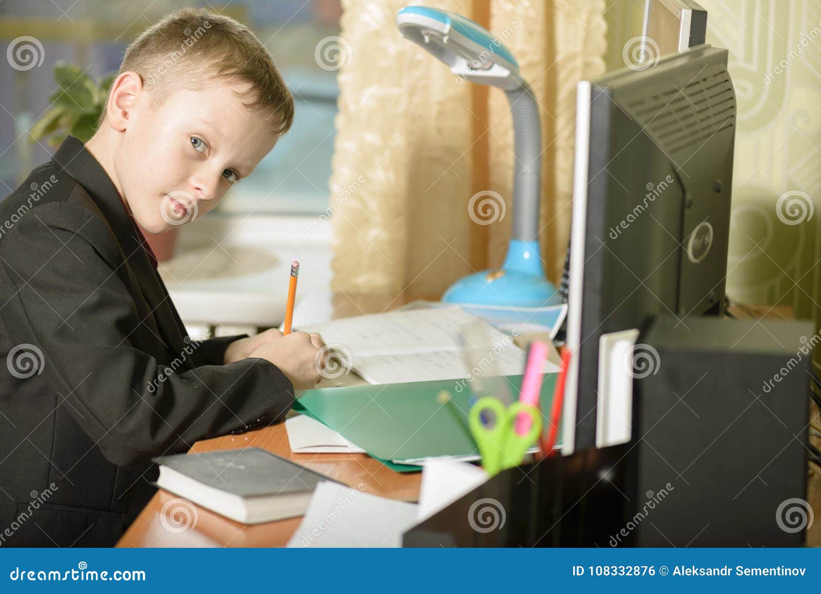 The Boy Works in His Office on a Personal Computer.he Writes a L Stock ...