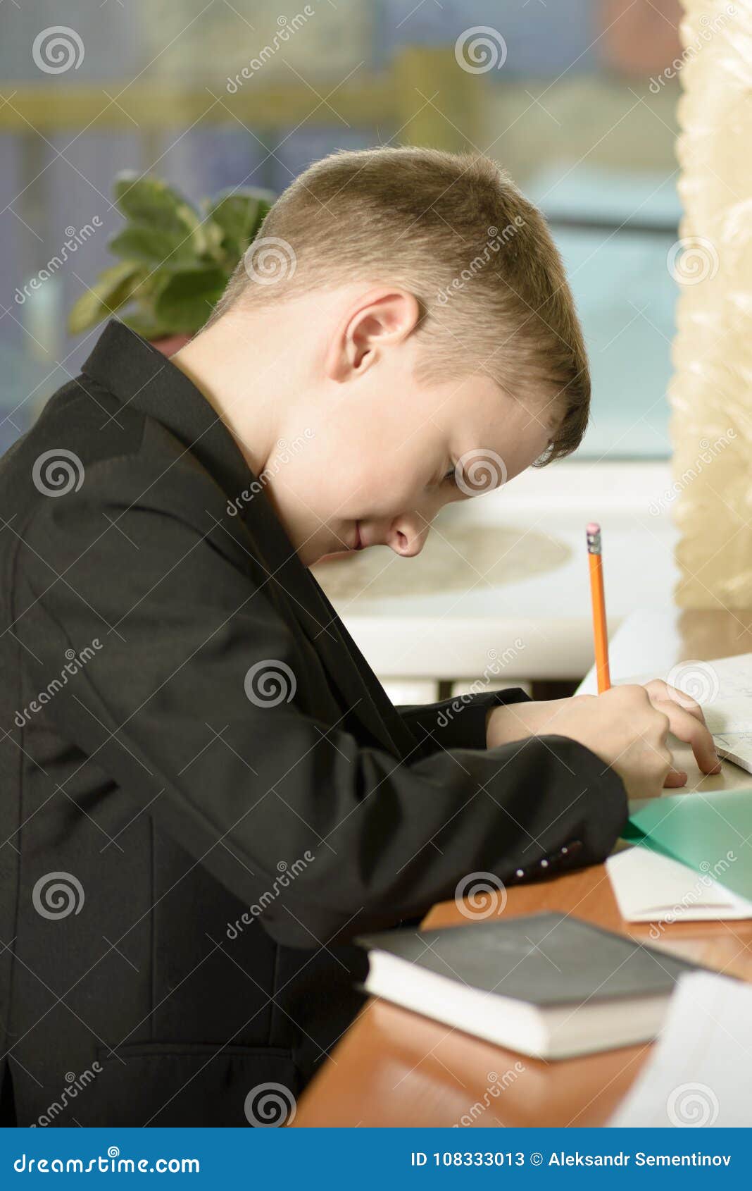 The Boy Works in His Office on a Personal Computer.he Writes a L Stock ...