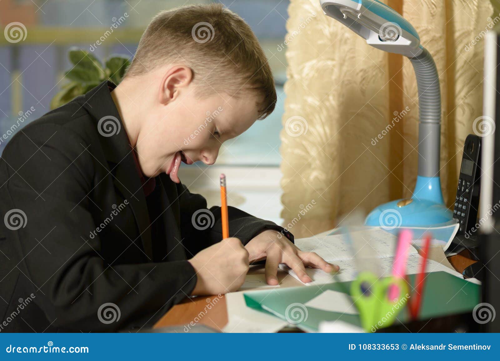 The Boy Works in His Office on a Personal Computer.he Writes a L Stock ...