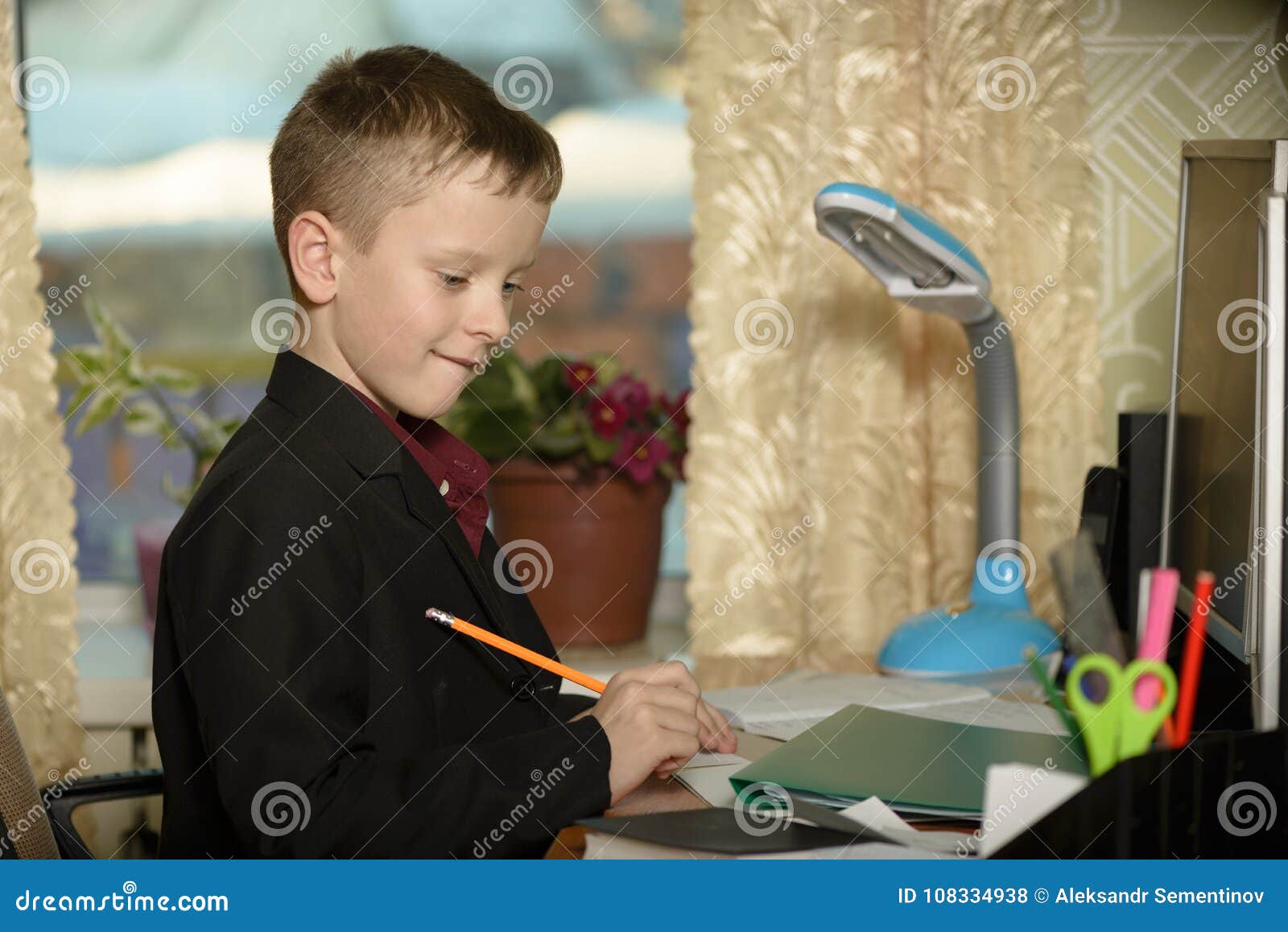 The Boy Works in His Office on a Personal Computer.he Writes a L Stock ...