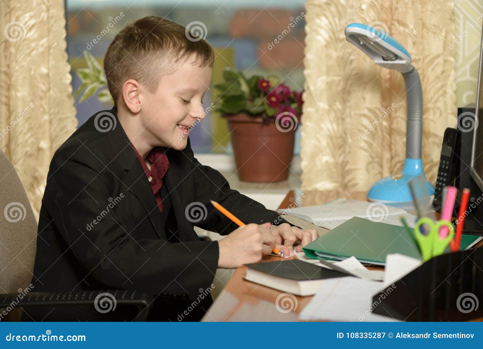 The Boy Works in His Office on a Personal Computer.he Writes a L Stock ...