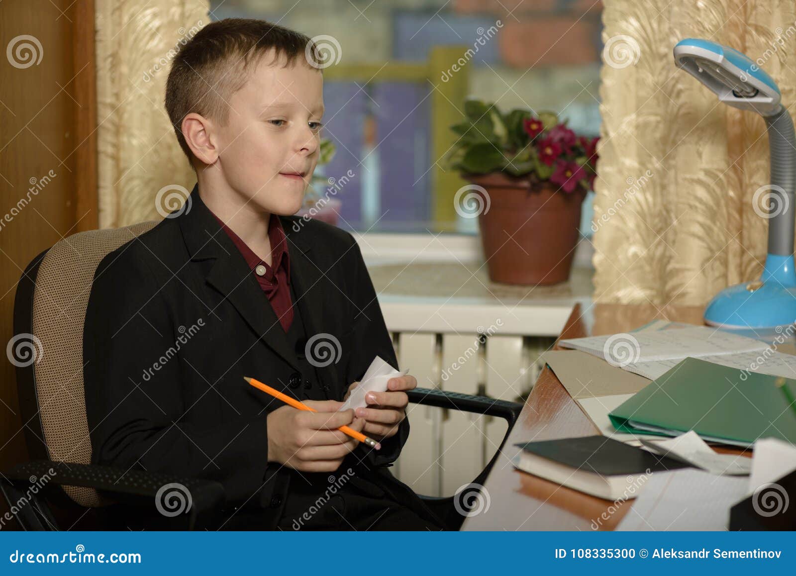 The Boy Works in His Office on a Personal Computer.he Writes a L Stock ...