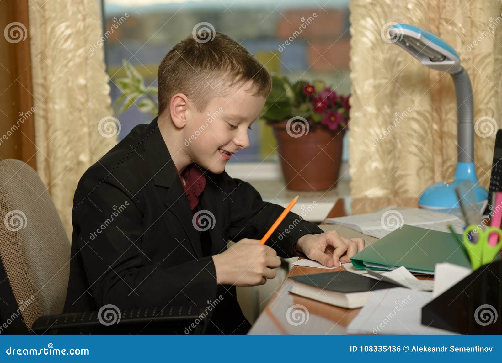 The Boy Works in His Office on a Personal Computer.he Writes a L Stock ...