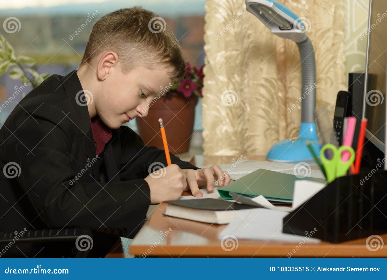 The Boy Works in His Office on a Personal Computer.he Writes a L Stock ...