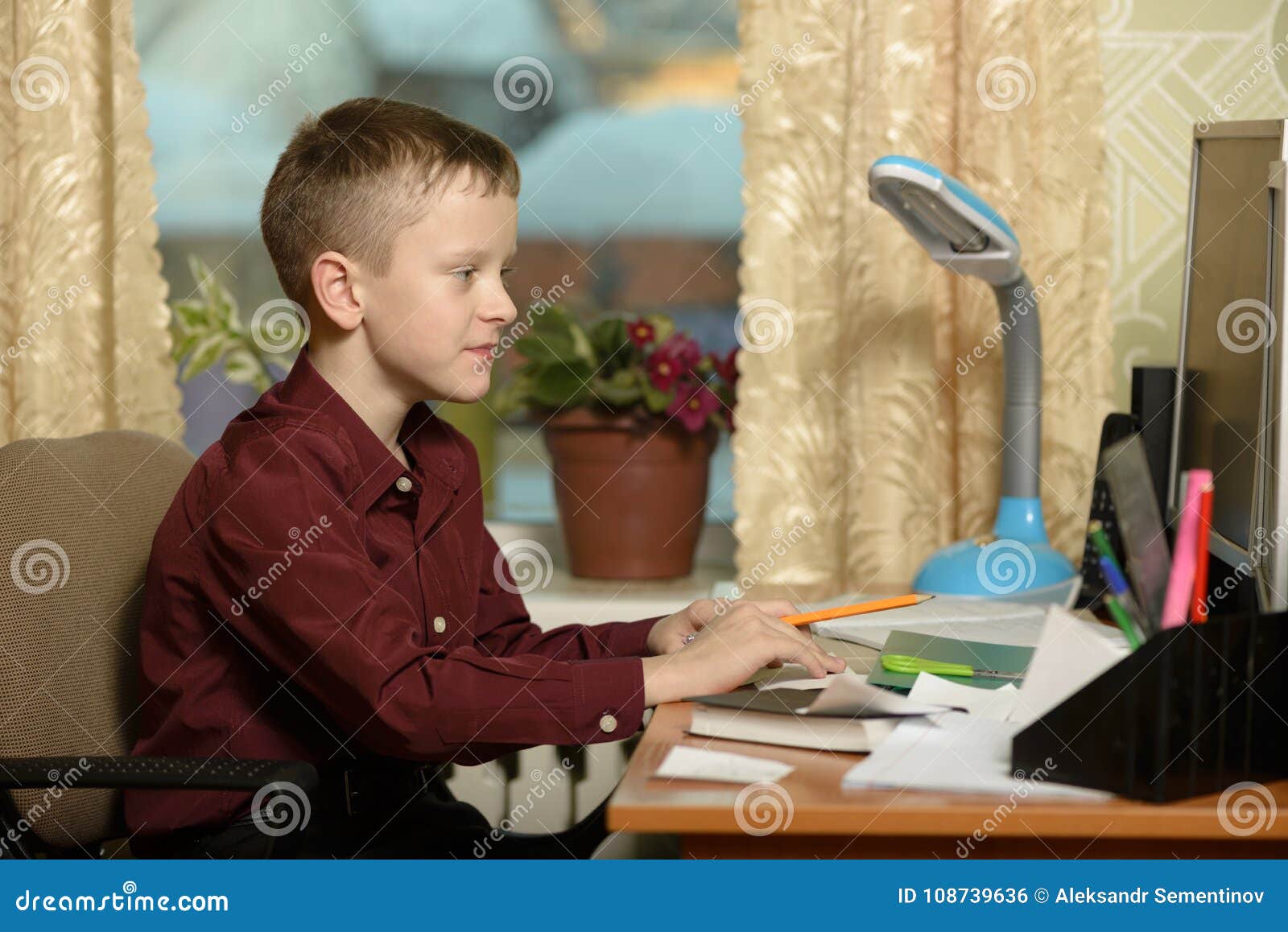 The Boy Works in His Office on a Personal Computer.Writes the Te Stock ...