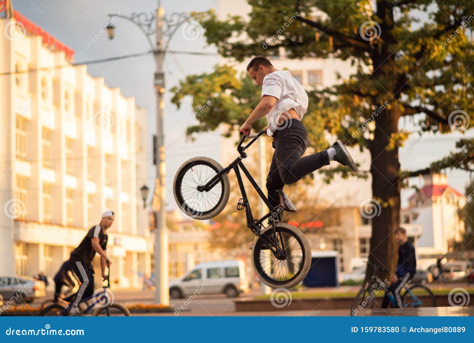The Guy Performs a Stunt on the BMX, Jumping from the Parapet High Up ...