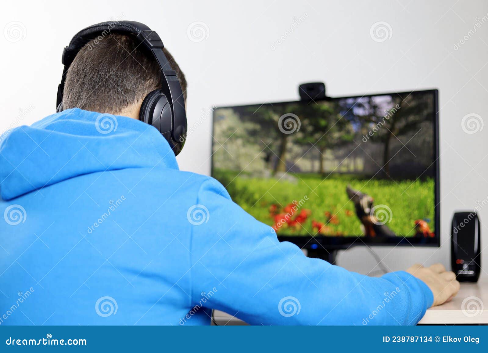 Guy in Headphones Playing a Computer Game on Desktop PC Stock Photo ...