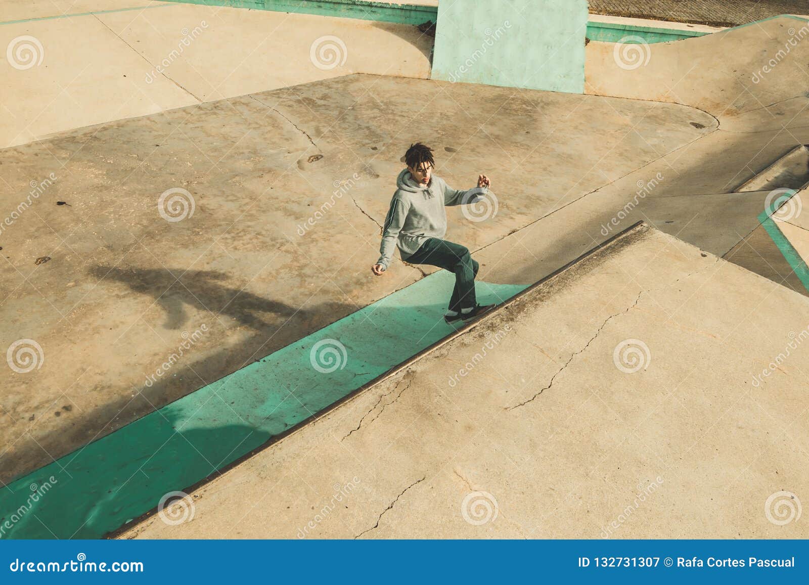 Guy Practicing Skateboarding and Doing Tricks in a Skatepark Stock ...