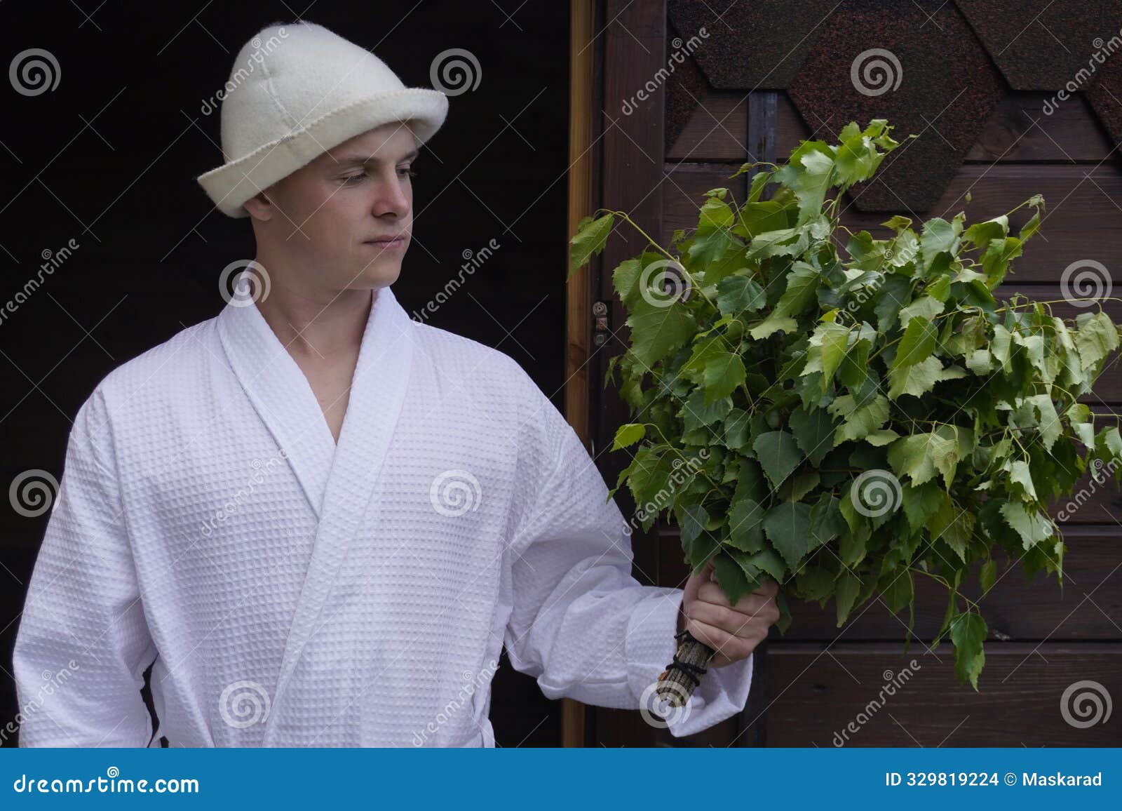 Guy is Preparing for Bath Procedures, Made a Birch Broom and Poses on ...