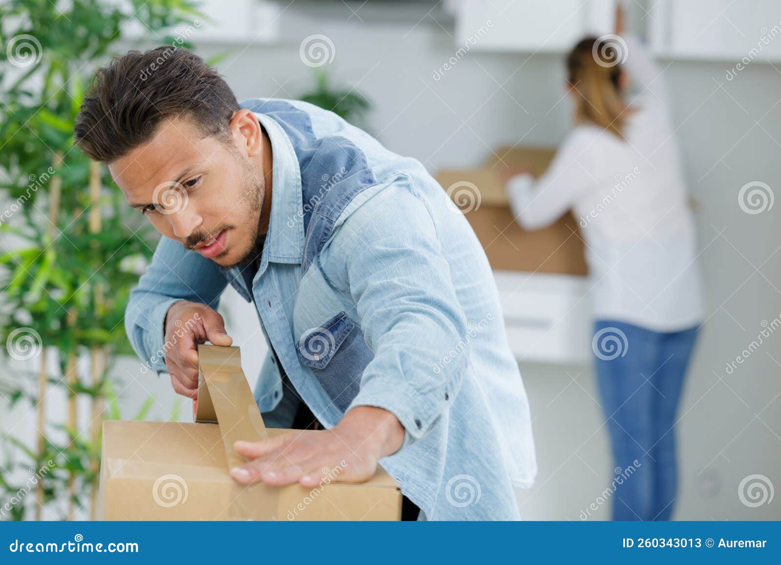 Guy preparing carton stock image. Image of couple, close - 260343013