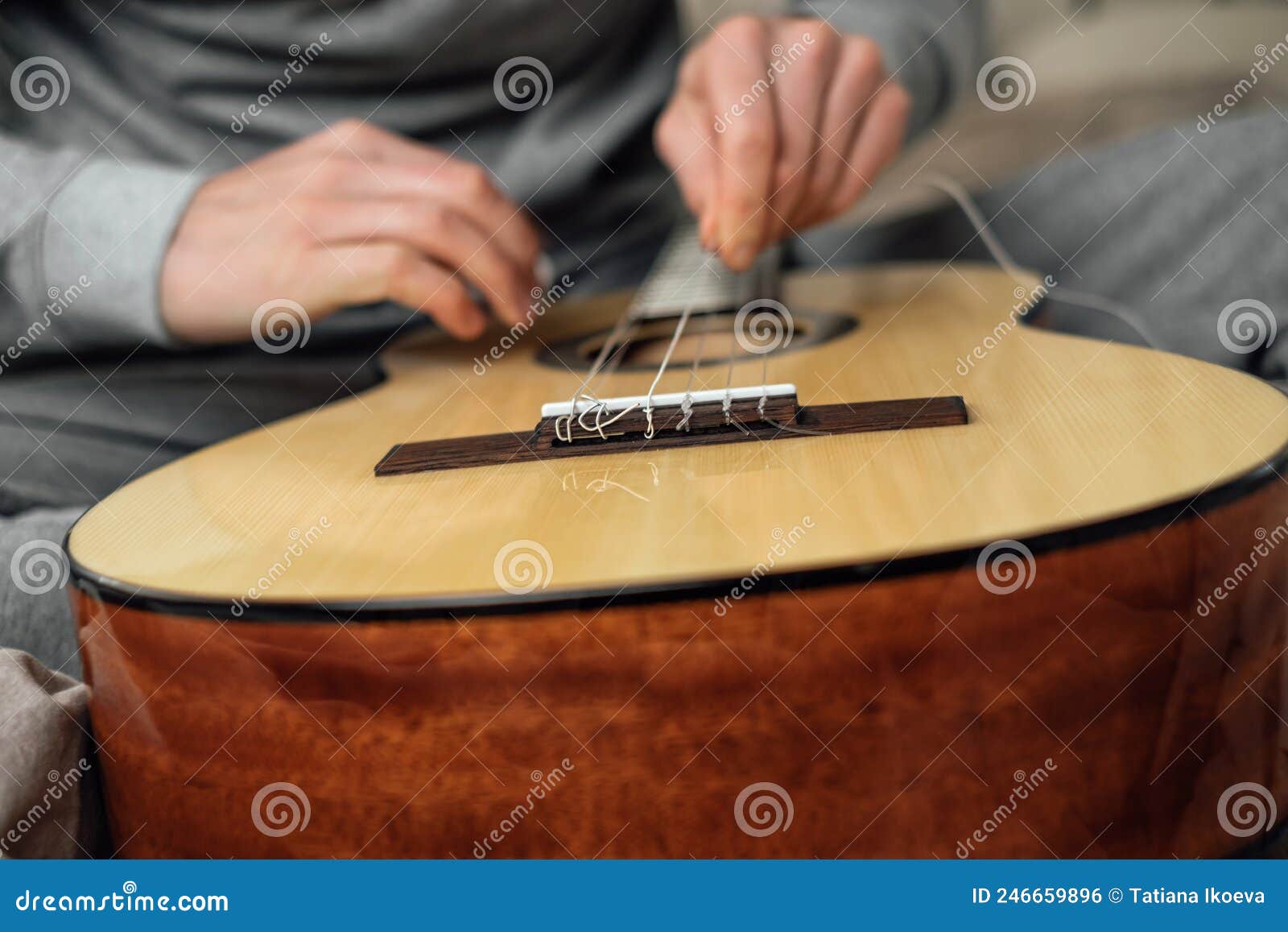 The Guy Pulls a New String on an Acoustic Guitar Stock Photo - Image of ...
