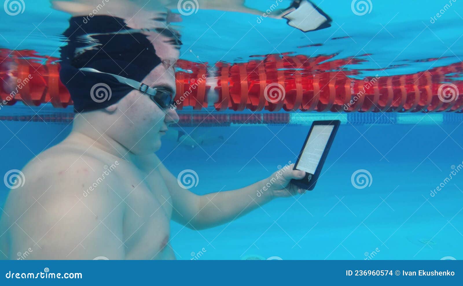 The Guy is Reading an Electronic Book Underwater. Stock Photo - Image ...
