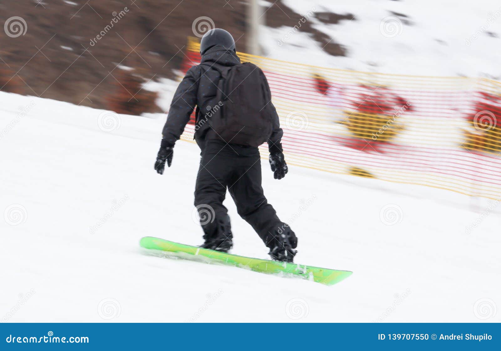 A Guy is Riding a Snowboard from a Mountain in Winter Stock Photo ...
