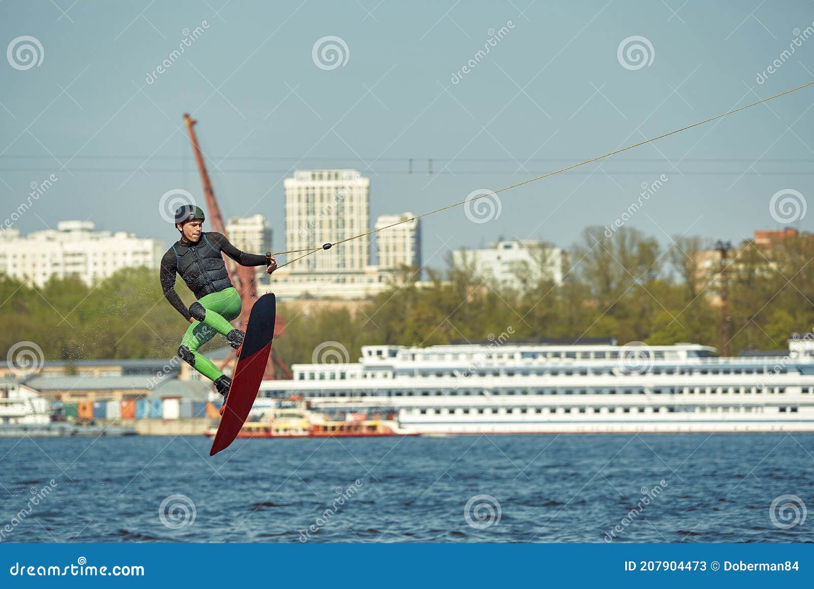 The Guy is Riding a Wakeboard on the River. Active and Extreme Sports ...