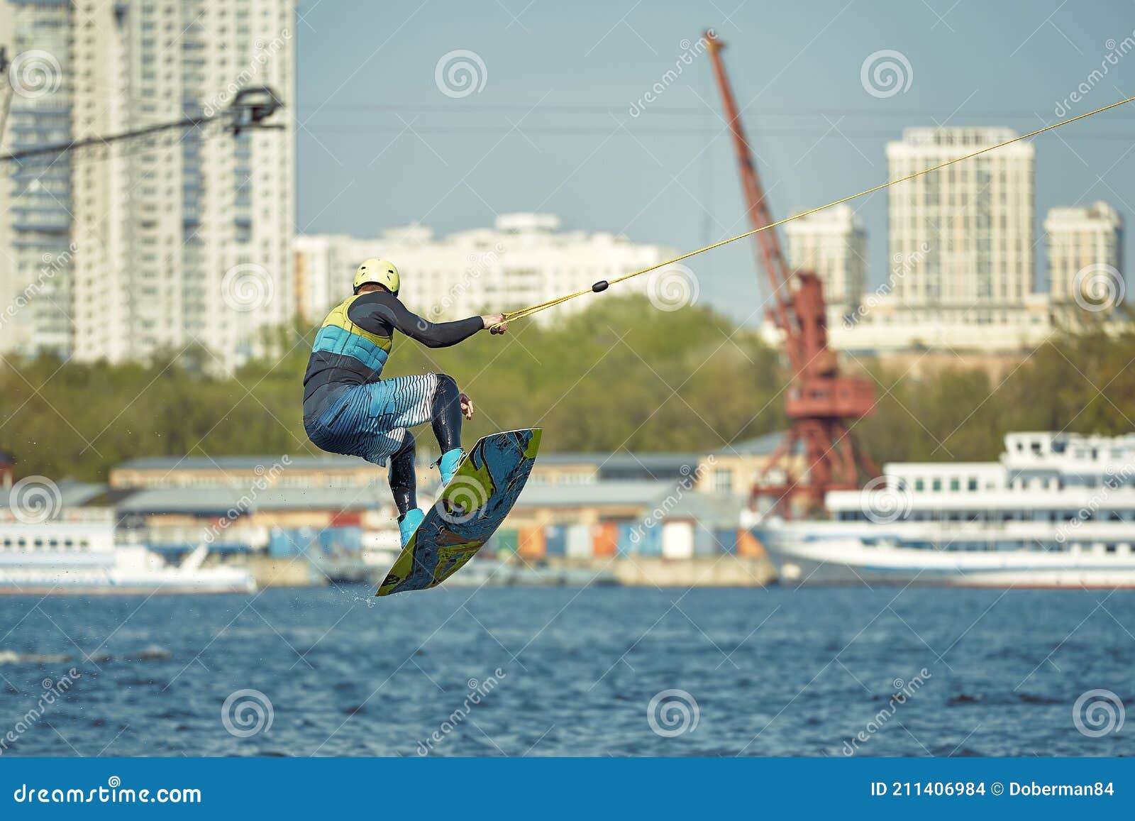 The Guy is Riding a Wakeboard on the River. Active and Extreme Sports ...