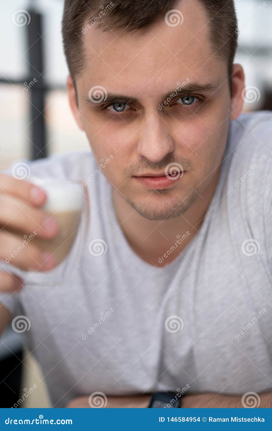 Guy`s Piercing Gaze. a Young Guy is Sitting in a Cafe Stock Photo ...