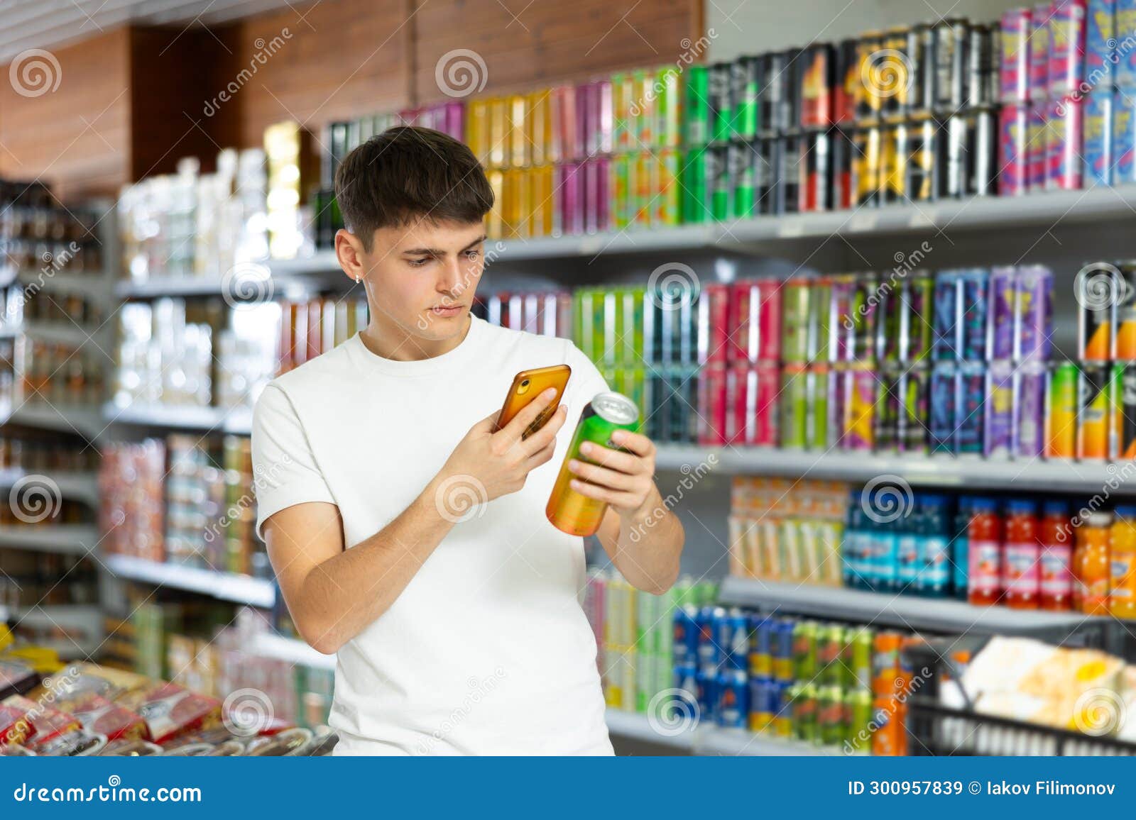 Guy Scans Bar Code from Label of an Aluminum Can with Drink in Grocery ...