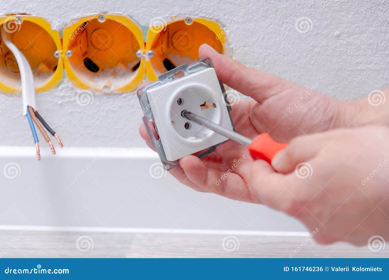 The Guy Sets the Sockets in the Room. Repair in the House Stock Photo ...