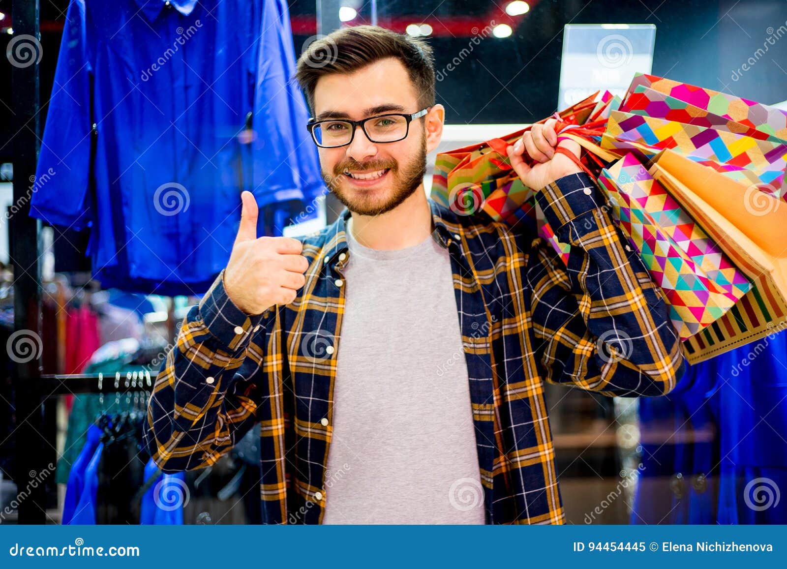 Guy shopping in a mall stock image. Image of looking - 94454445