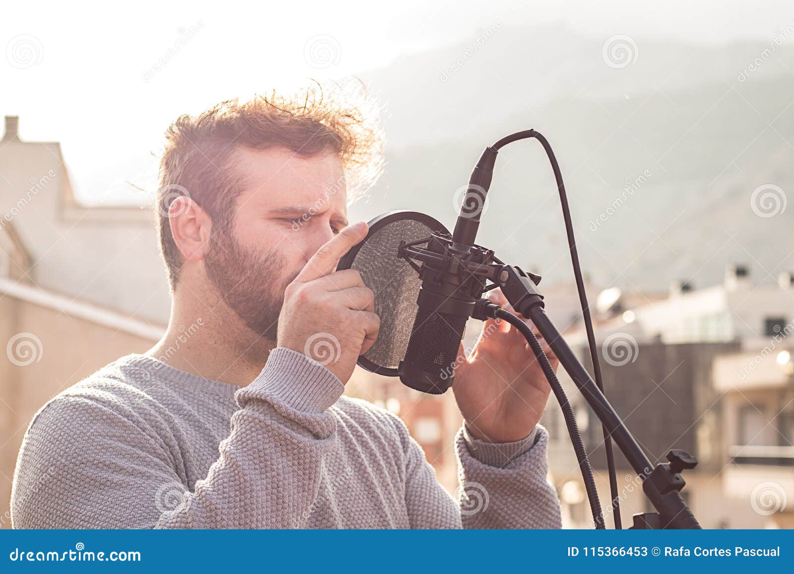 Guy singing on a rooftop stock image. Image of leisure - 115366453