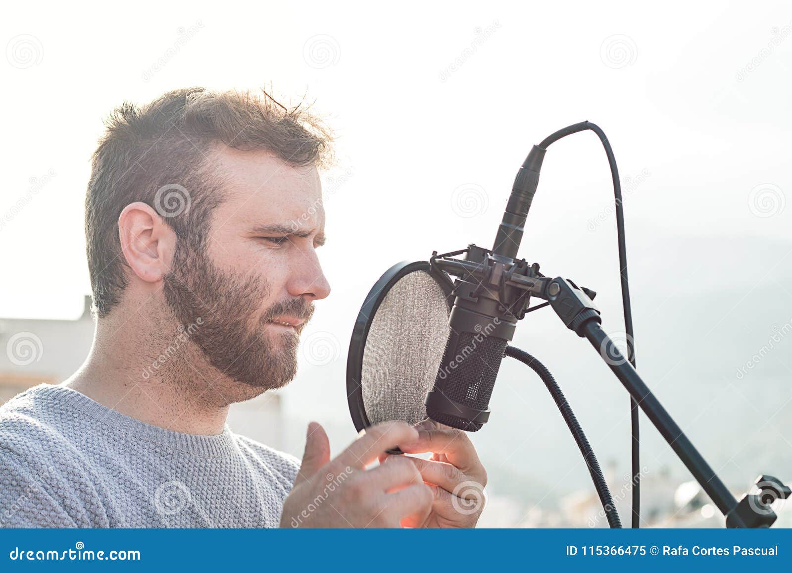Guy singing on a rooftop stock image. Image of happy - 115366475
