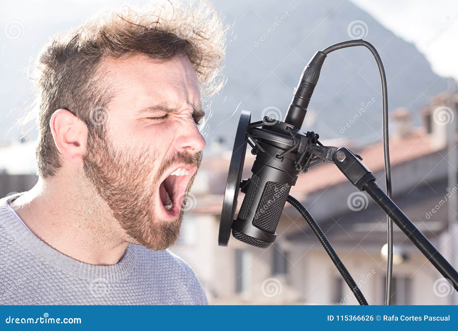 Guy singing on a rooftop stock photo. Image of balcony - 115366626
