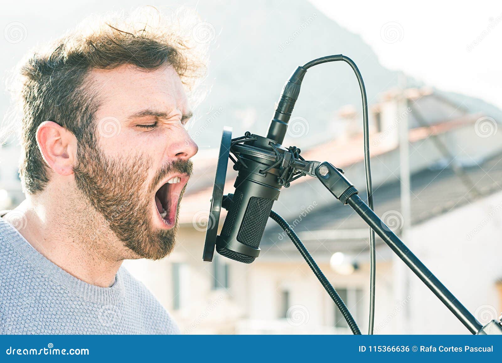 Guy singing on a rooftop stock photo. Image of balcony - 115366636