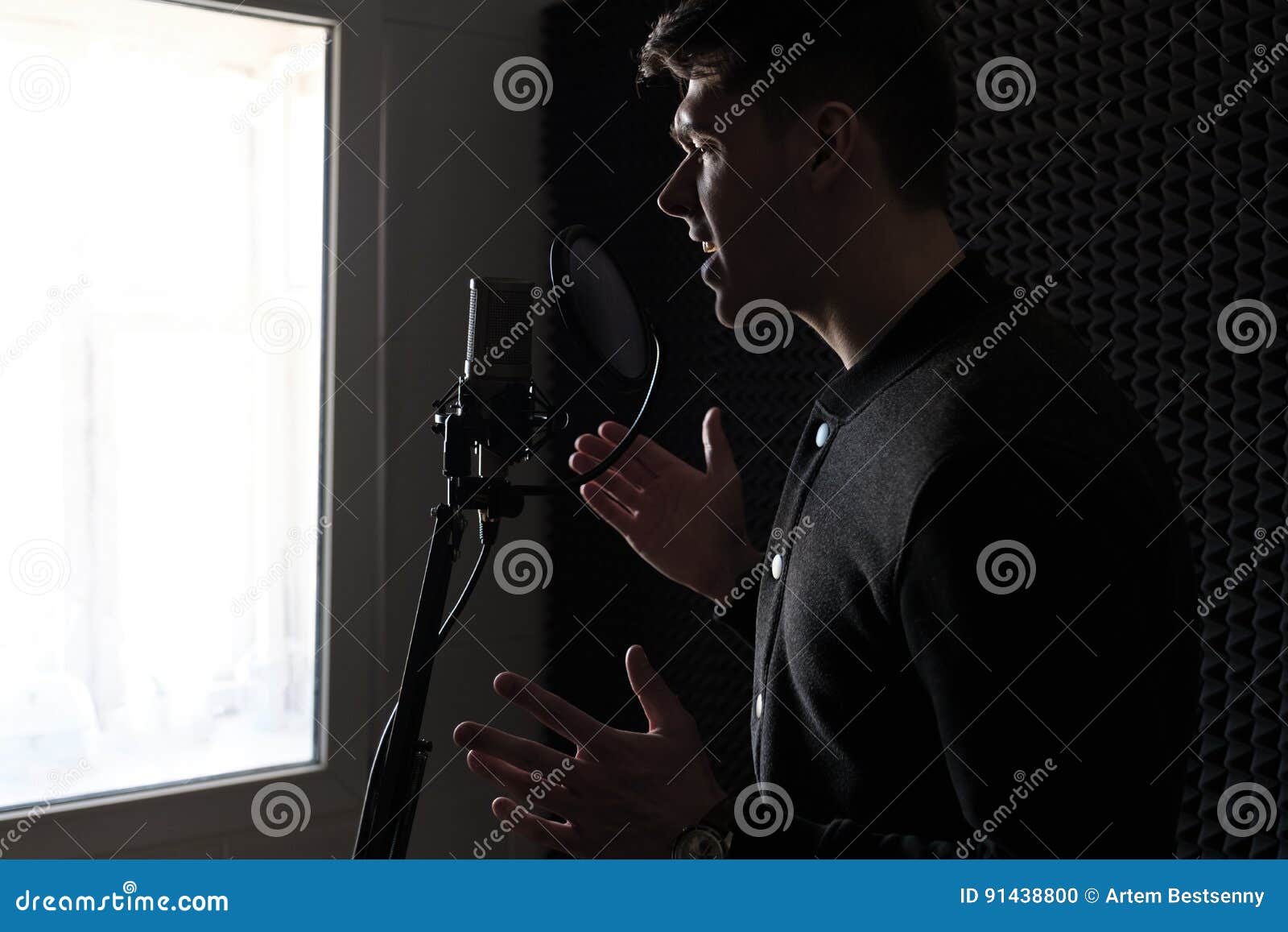 The Guy Sings in Front of the Microphone on the Stand Standing in ...