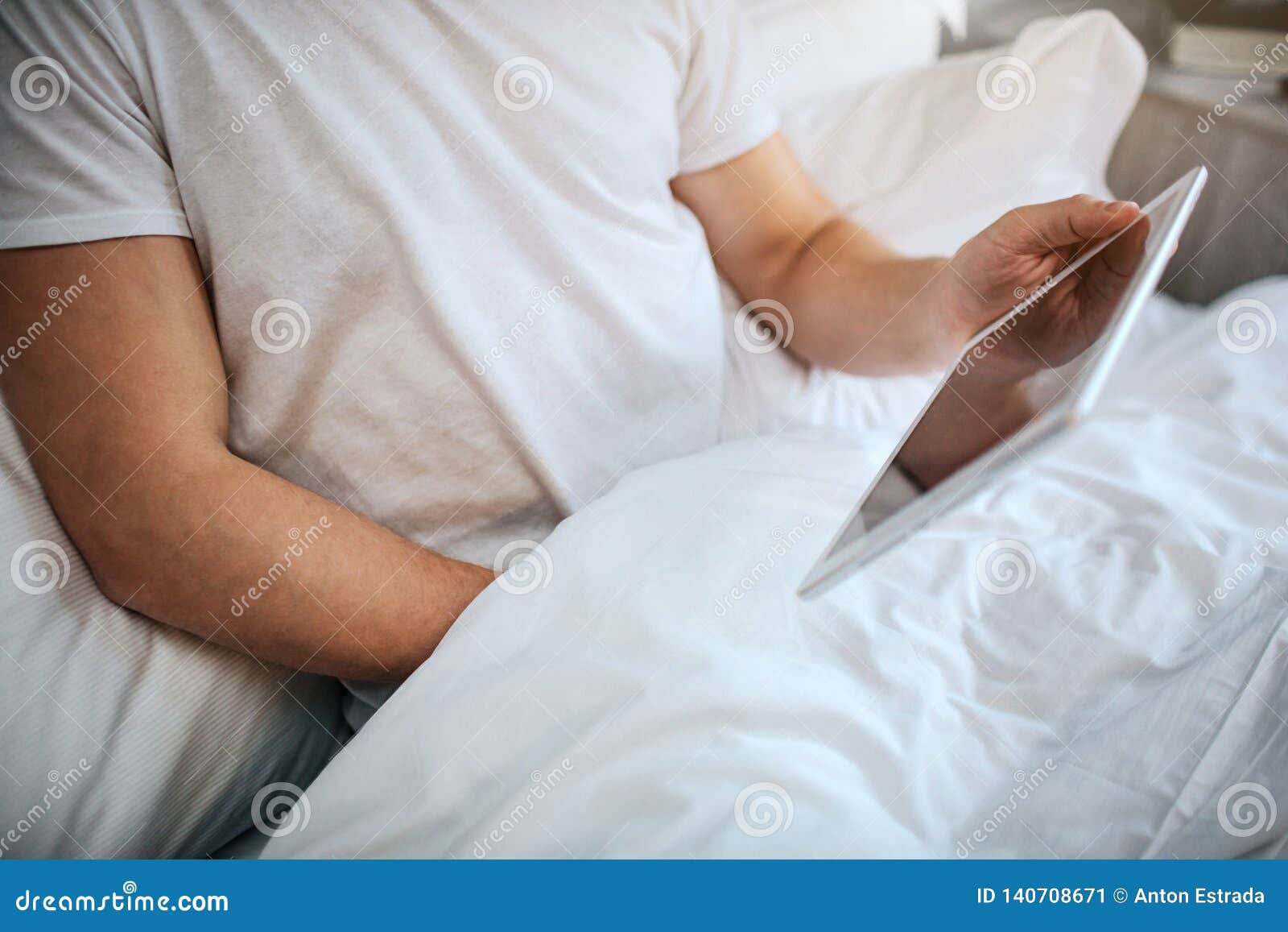 Guy Sit In Bed In The Morning He Hold Hand Under Blanket And
