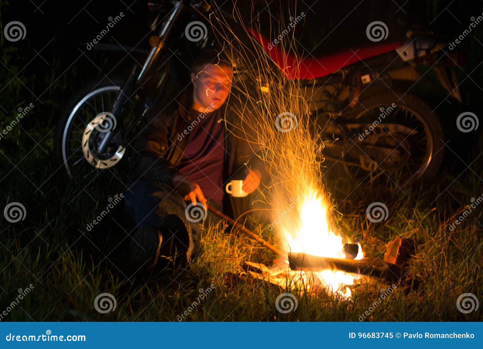 The Guy Sits with Cup of Tea by the Fire and Motorcycle at Night Stock ...