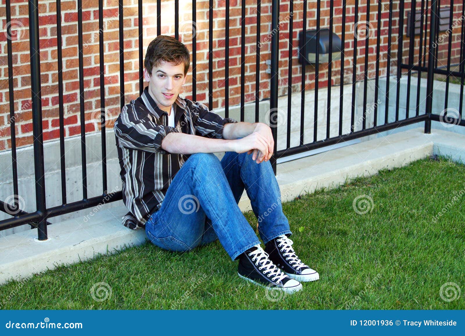 Guy Sitting Against Railing Stock Photo - Image of person, model: 12001936