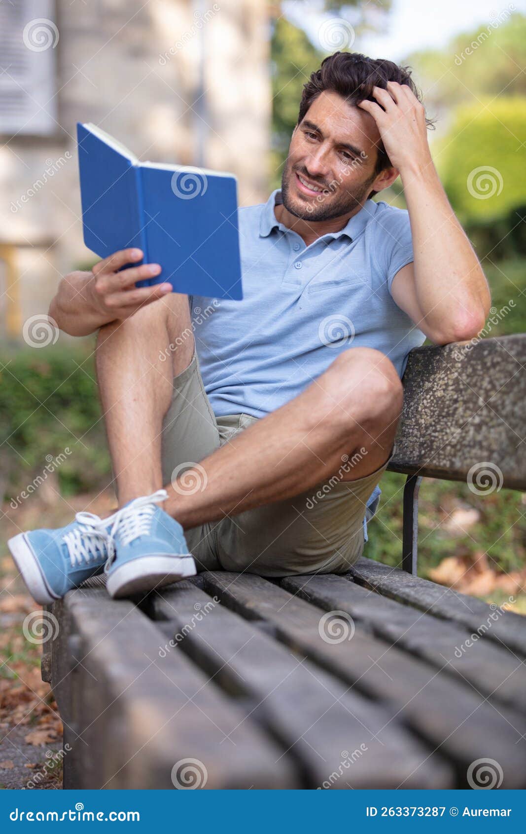 Guy Sitting on Bench in Park Reading Book Stock Image - Image of shirt ...