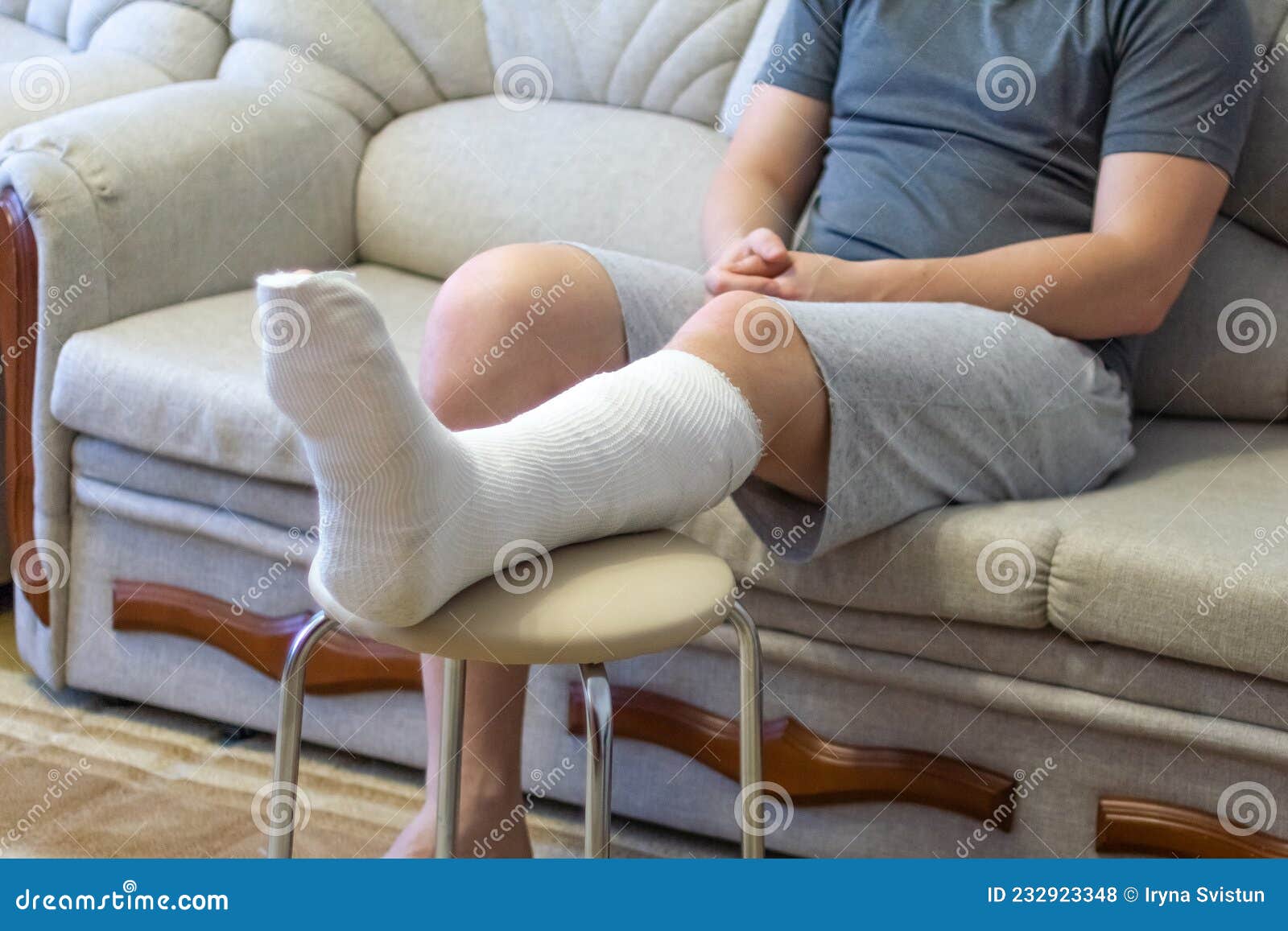 The Guy is Sitting on the Couch in a Cast. the Leg is in a Cast Stock ...