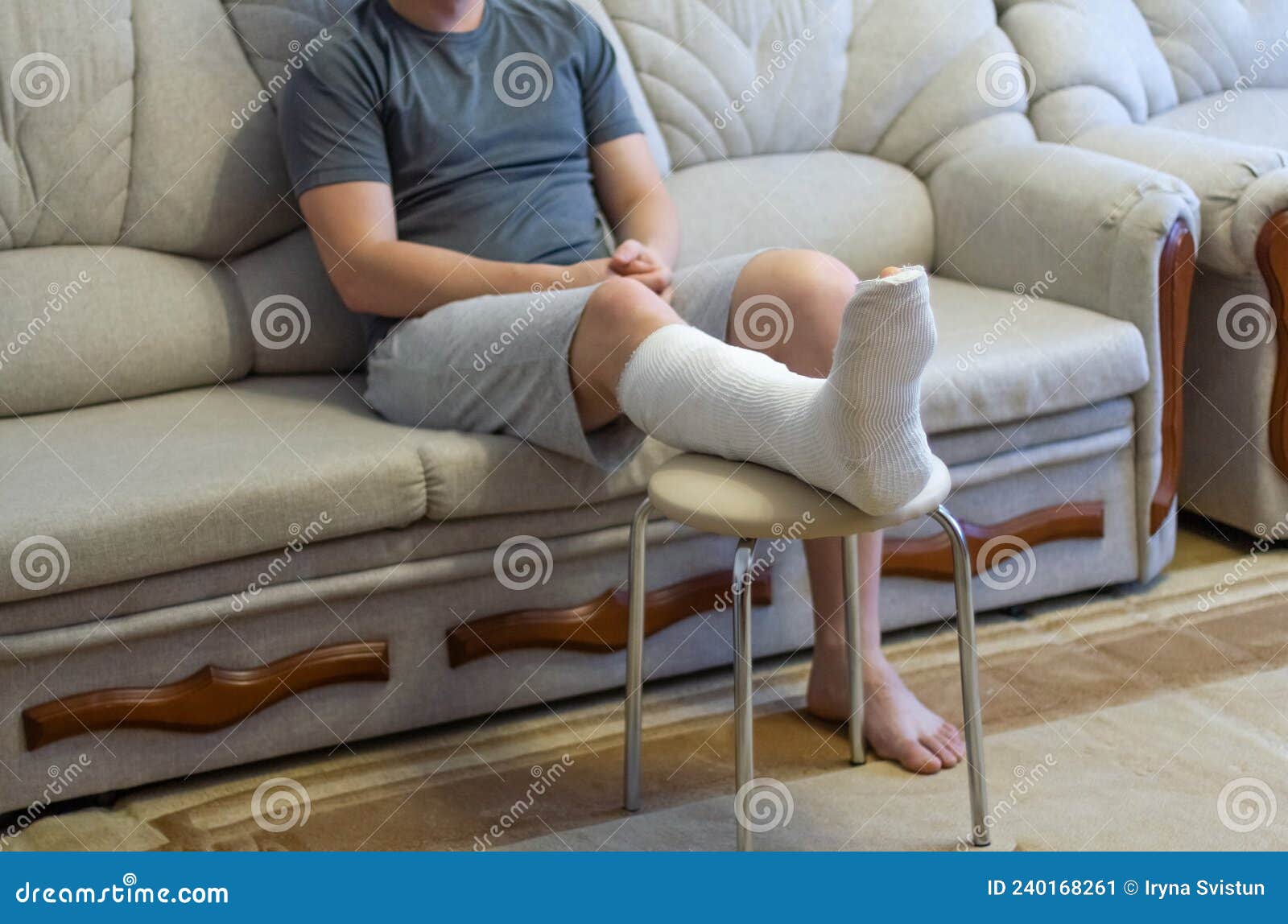 The Guy is Sitting on the Couch in a Cast. the Leg is in a Cast Stock ...