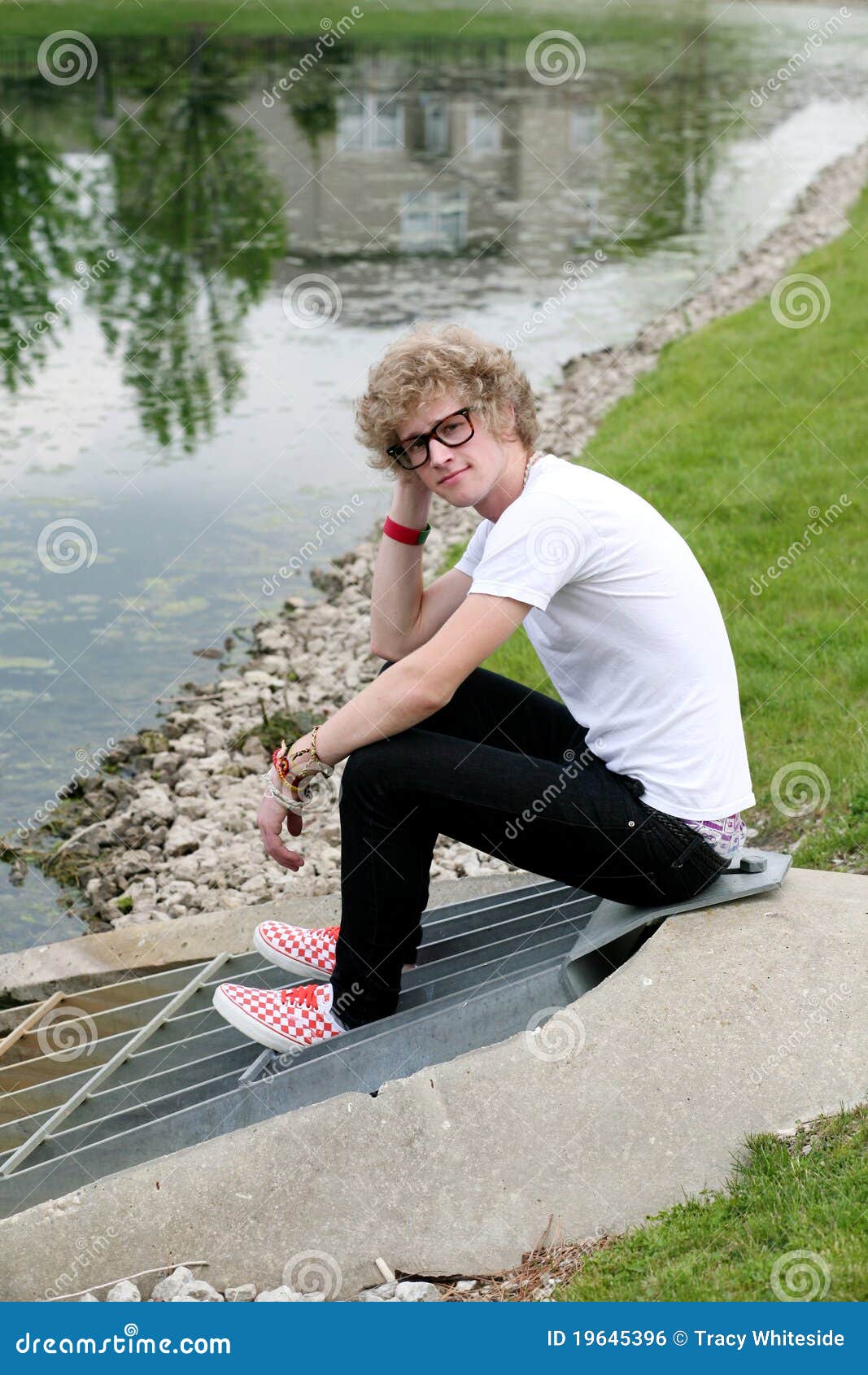 Guy Sitting Outside by Lake Stock Photo - Image of glasses, color: 19645396