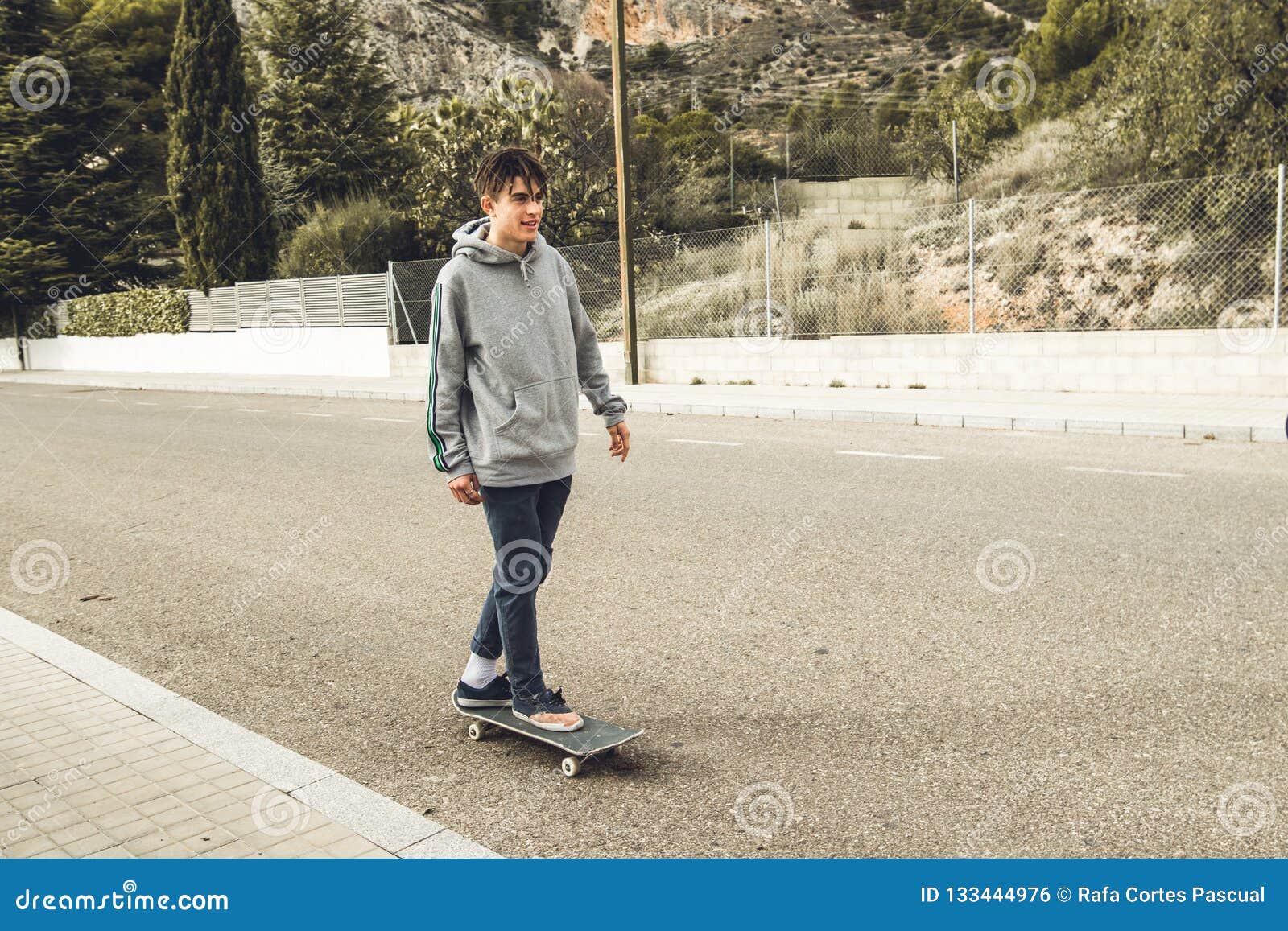 A Guy with a Skateboard Down the Street Stock Photo - Image of style ...